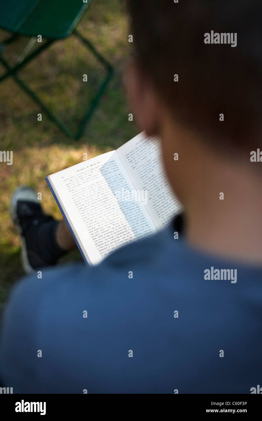 Man reading book outdoors Stock Photo - Alamy
