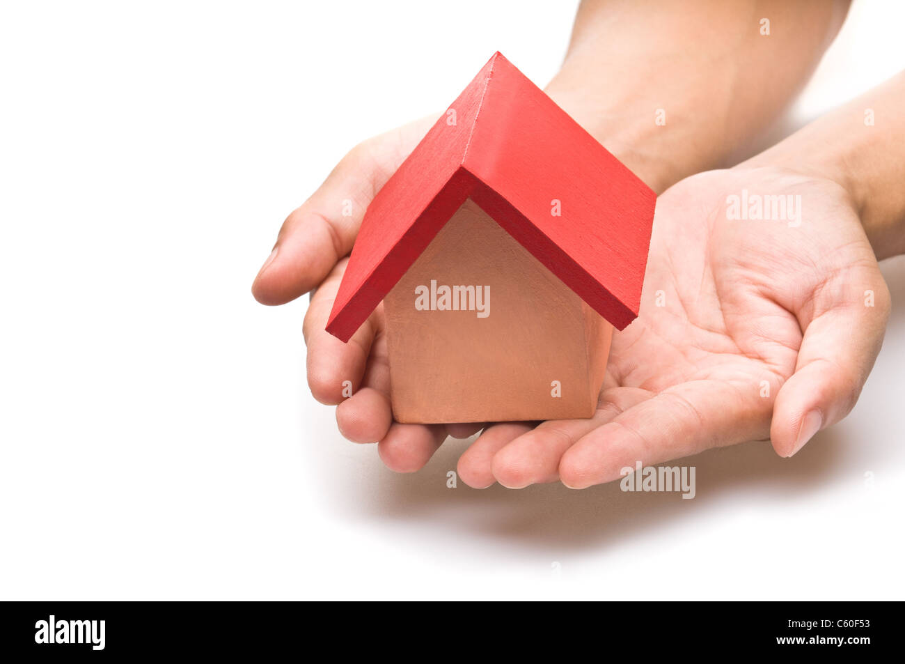 red roofed house over white in human hand Stock Photo - Alamy