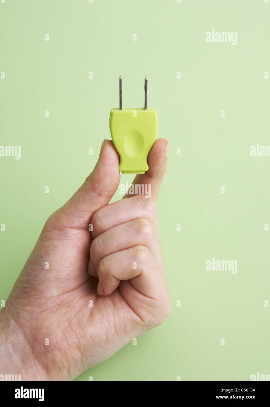 Hand holding plug Stock Photo - Alamy