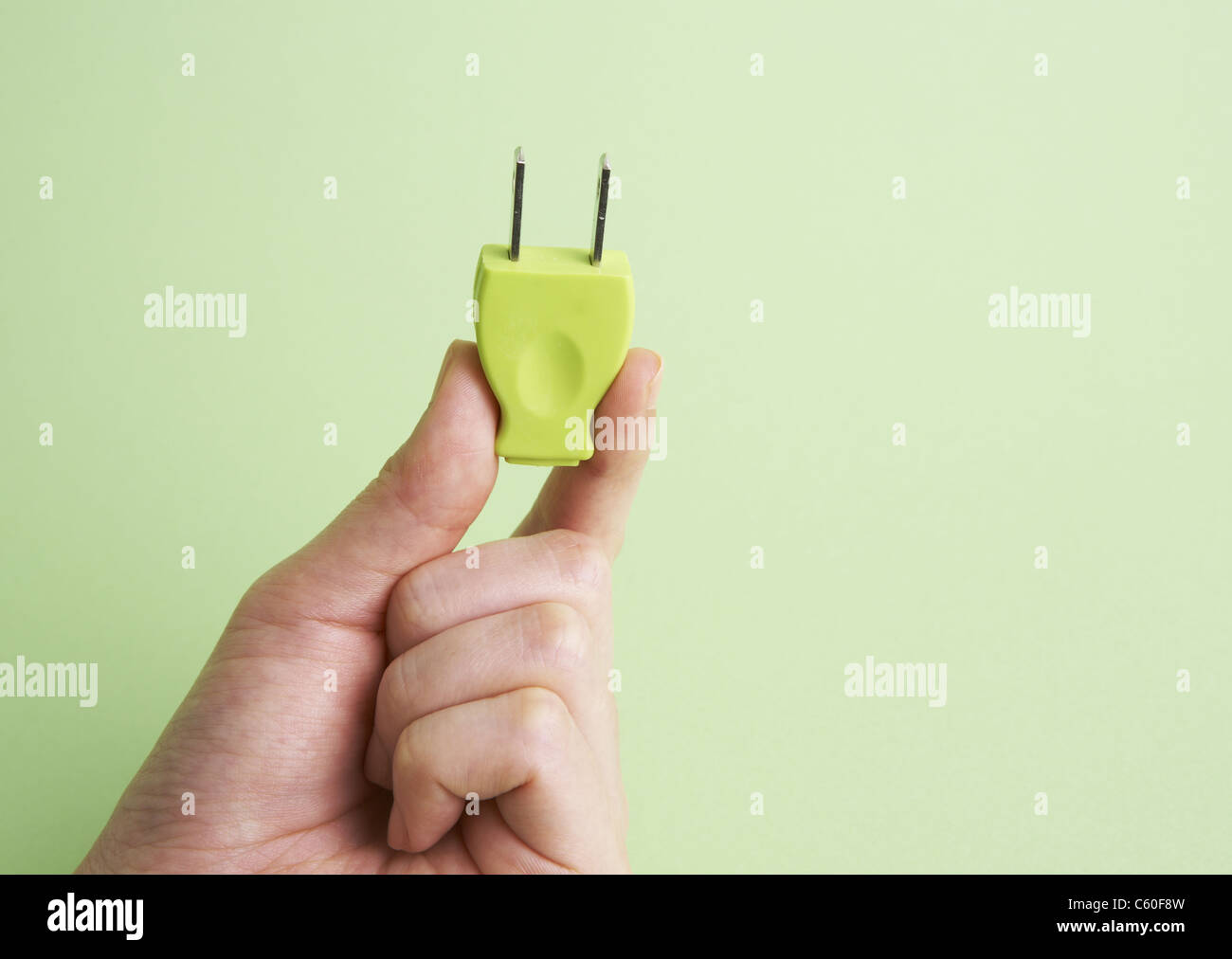 Hand holding plug Stock Photo - Alamy