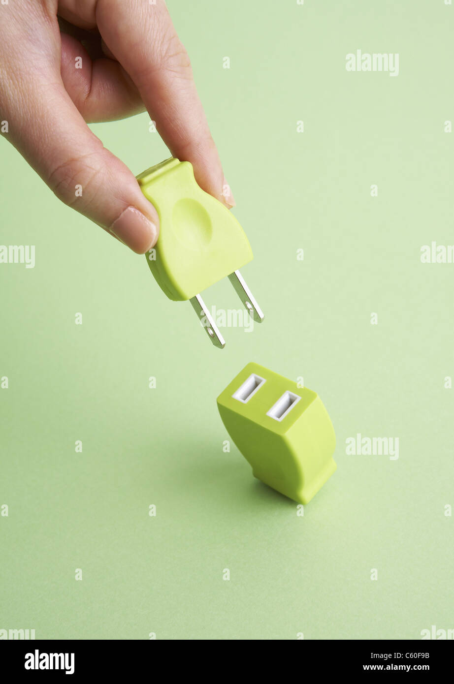Hand holding plug and outlet Stock Photo - Alamy