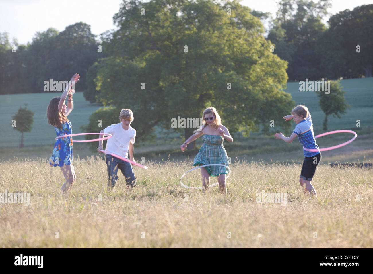 Children playing with hula hoops Stock Photo - Alamy