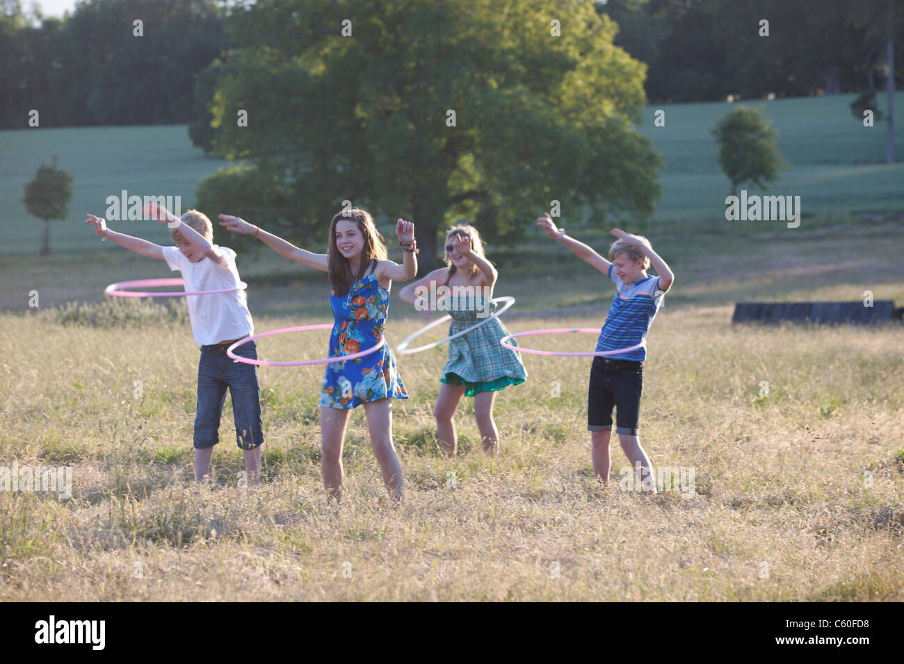 Children playing with hula hoops Stock Photo - Alamy