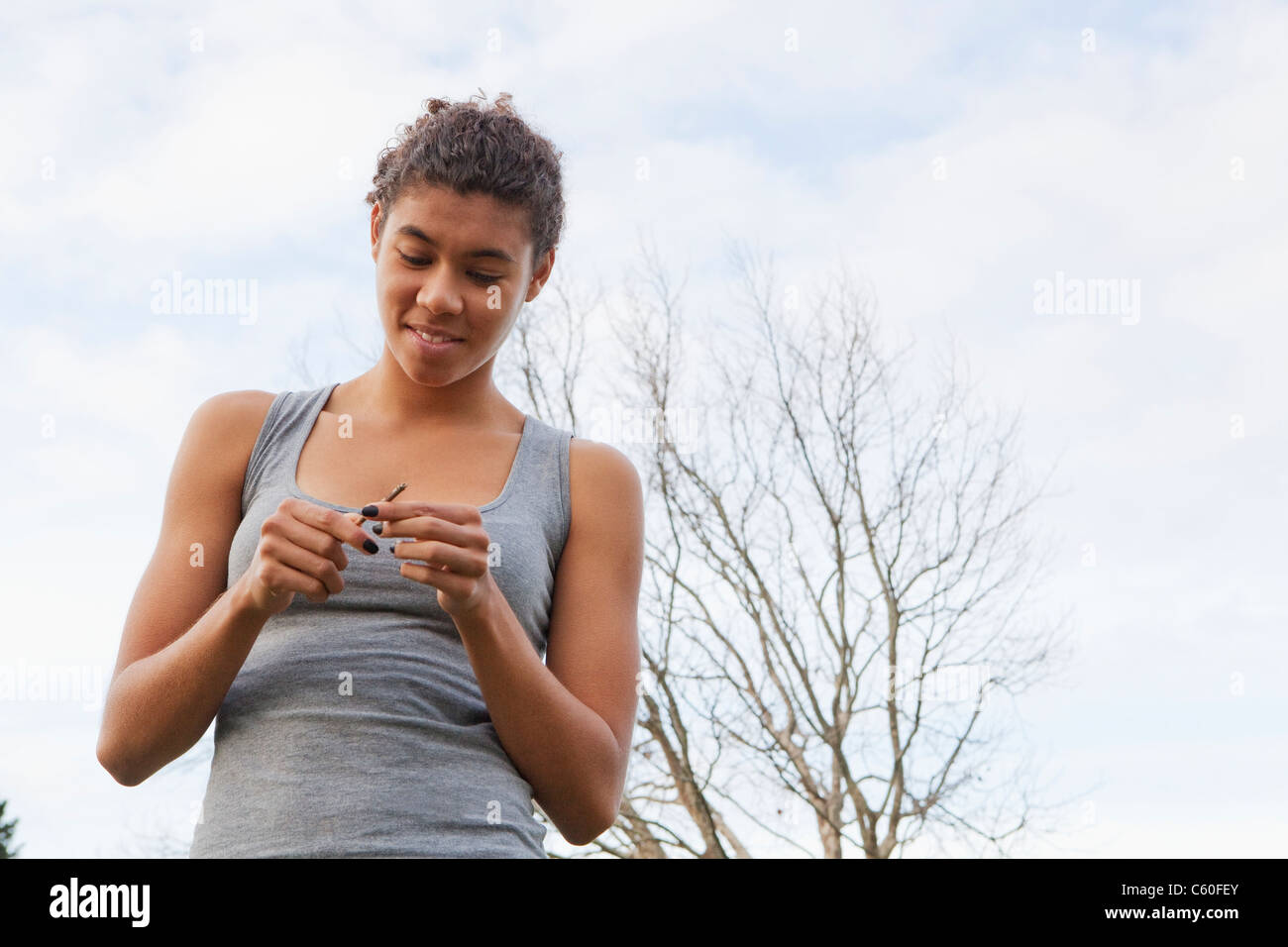 Woman examining twig outdoors Stock Photo - Alamy