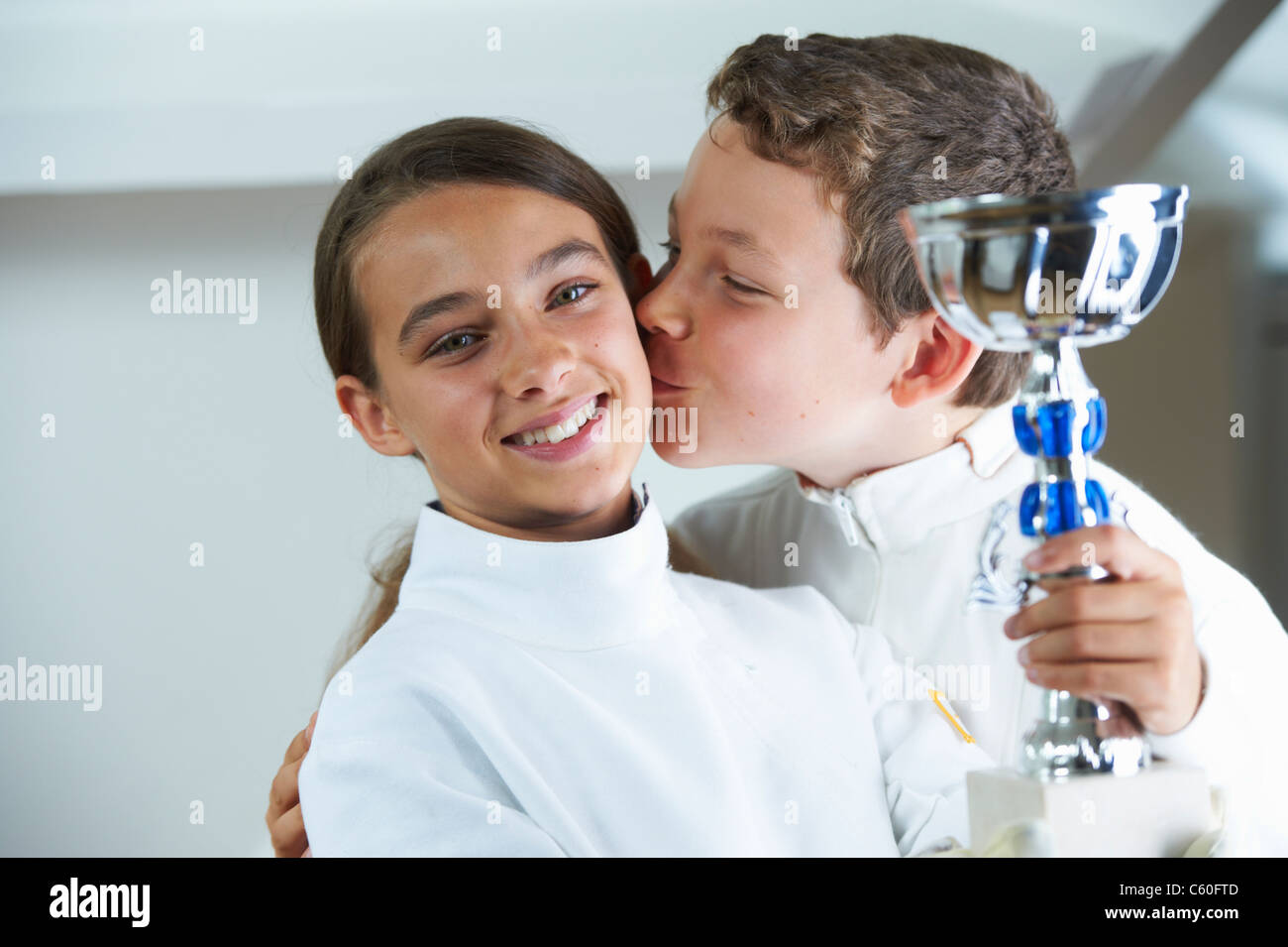 Boy kissing smiling fencing rival Stock Photo - Alamy