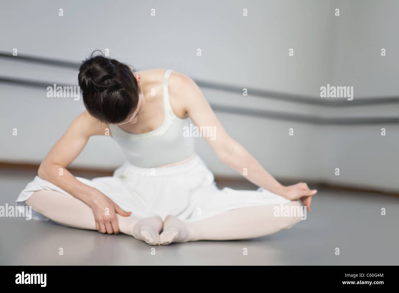 Ballet dancer stretching in studio Stock Photo - Alamy