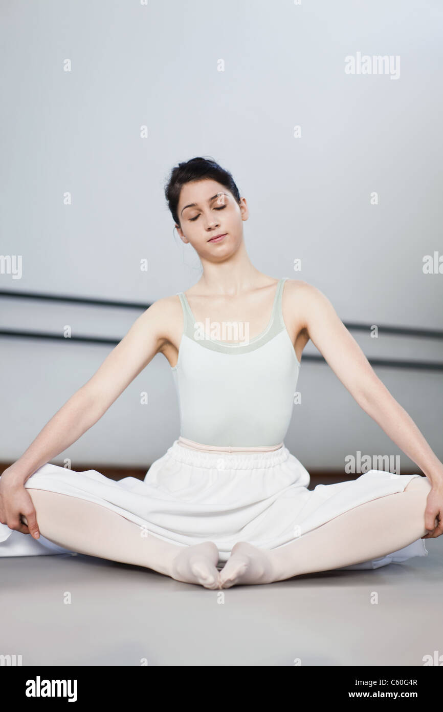 Ballet dancer stretching in studio Stock Photo - Alamy