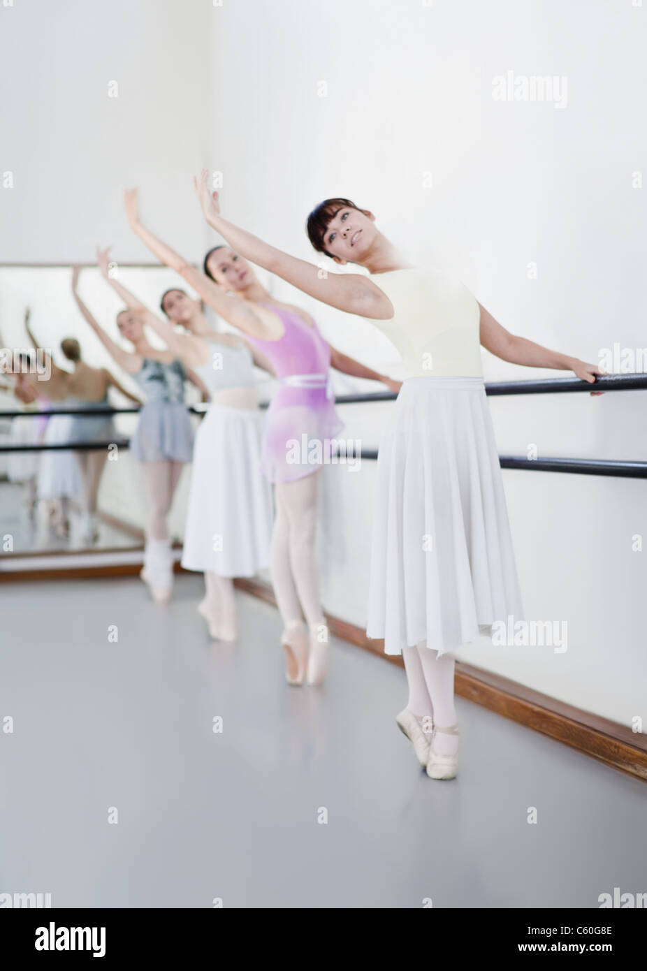 Ballet dancers posing at barre Stock Photo - Alamy
