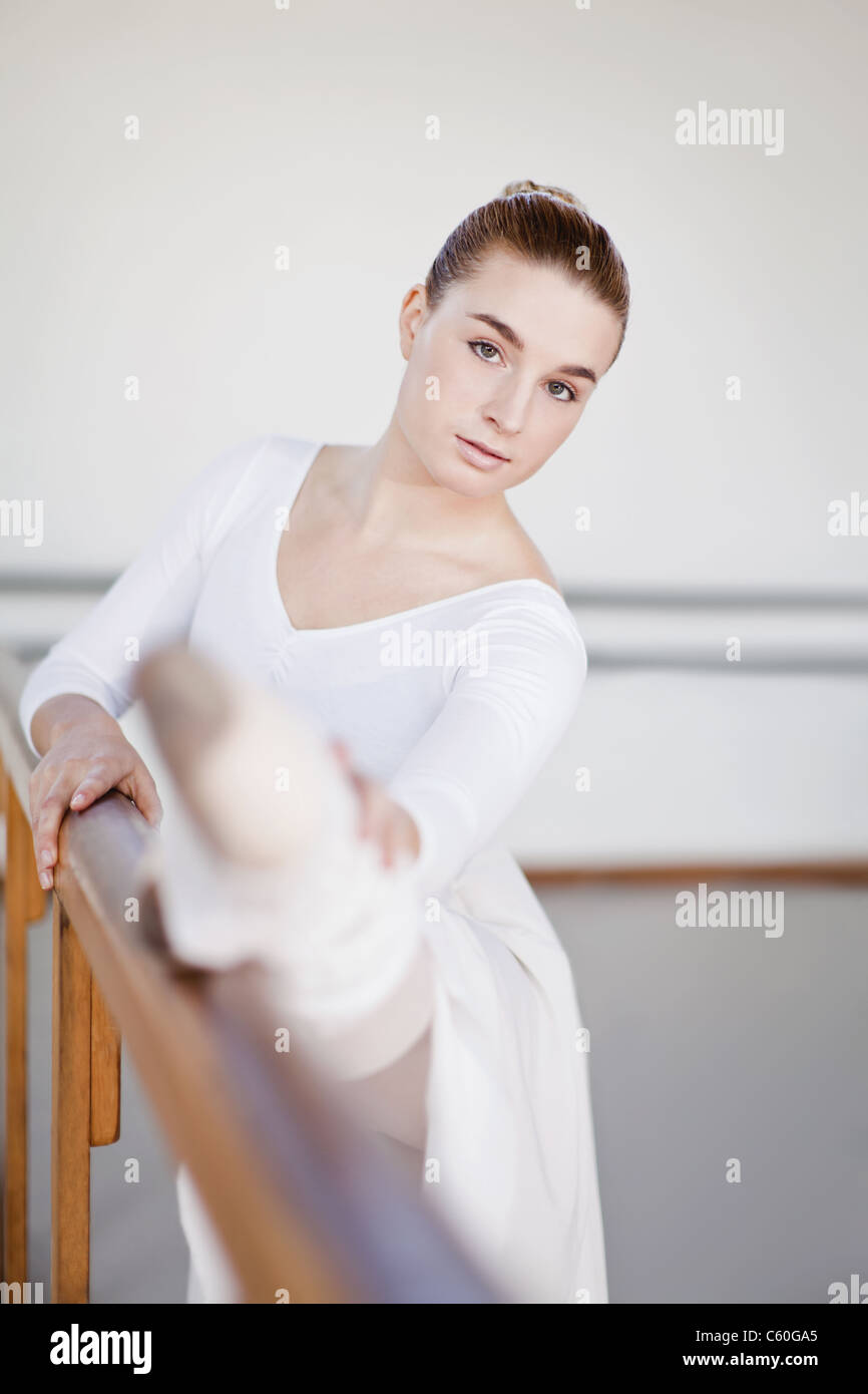 Ballet dancer stretching at barre Stock Photo - Alamy