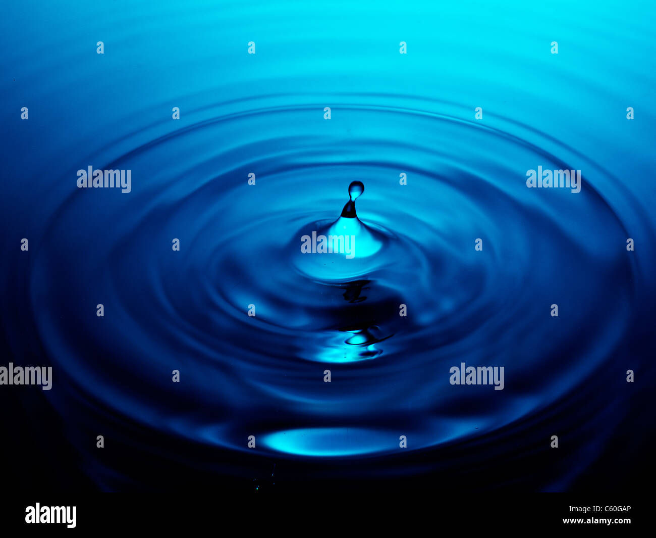 Water droplet, with blue ripples Stock Photo - Alamy