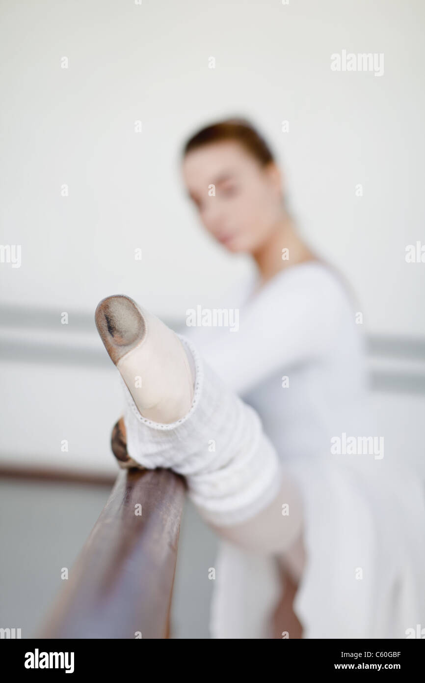 Ballet dancer stretching at barre Stock Photo - Alamy