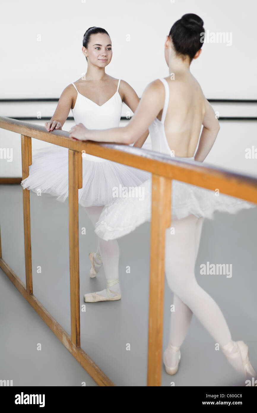 Ballet dancers posing at barre Stock Photo - Alamy