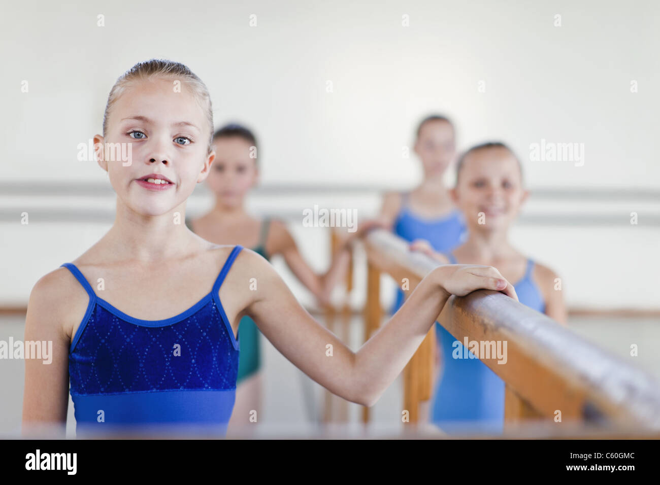 Ballet dancers standing at barre Stock Photo - Alamy