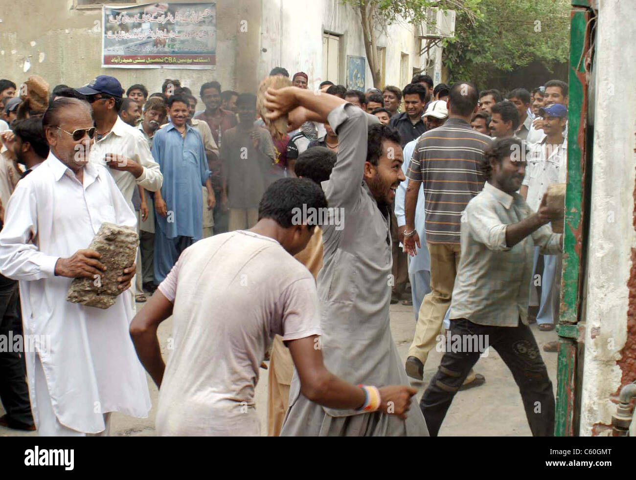 Angry protesters throw stones at main gate of Taluka City office during ...