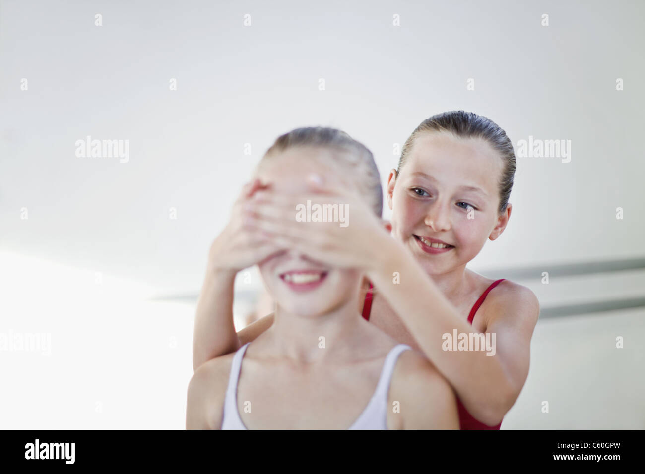 Ballet dancer covering friends eyes Stock Photo - Alamy