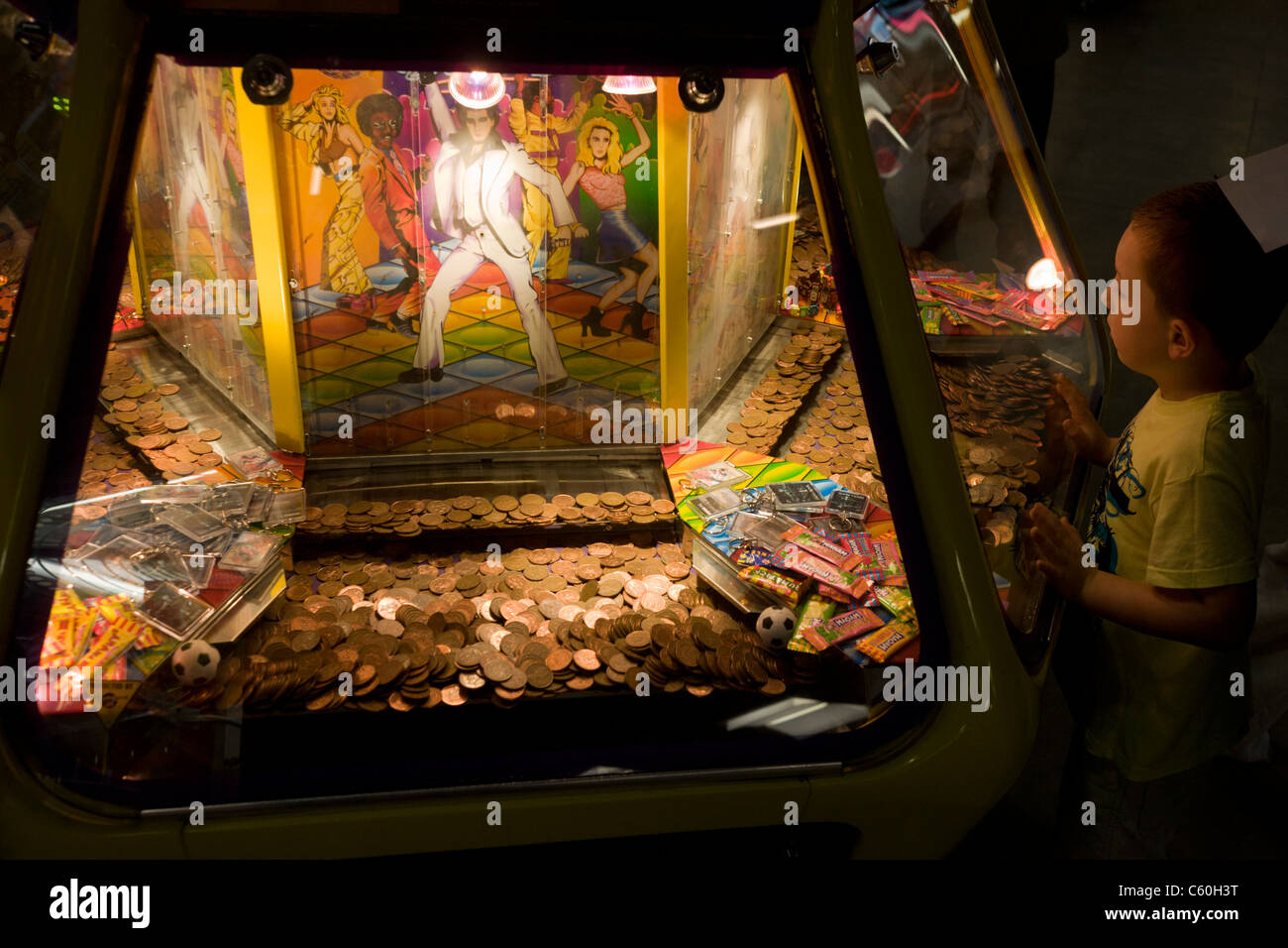 Playing a Penny push/fall game in the amusement arcade at Weston-super ...