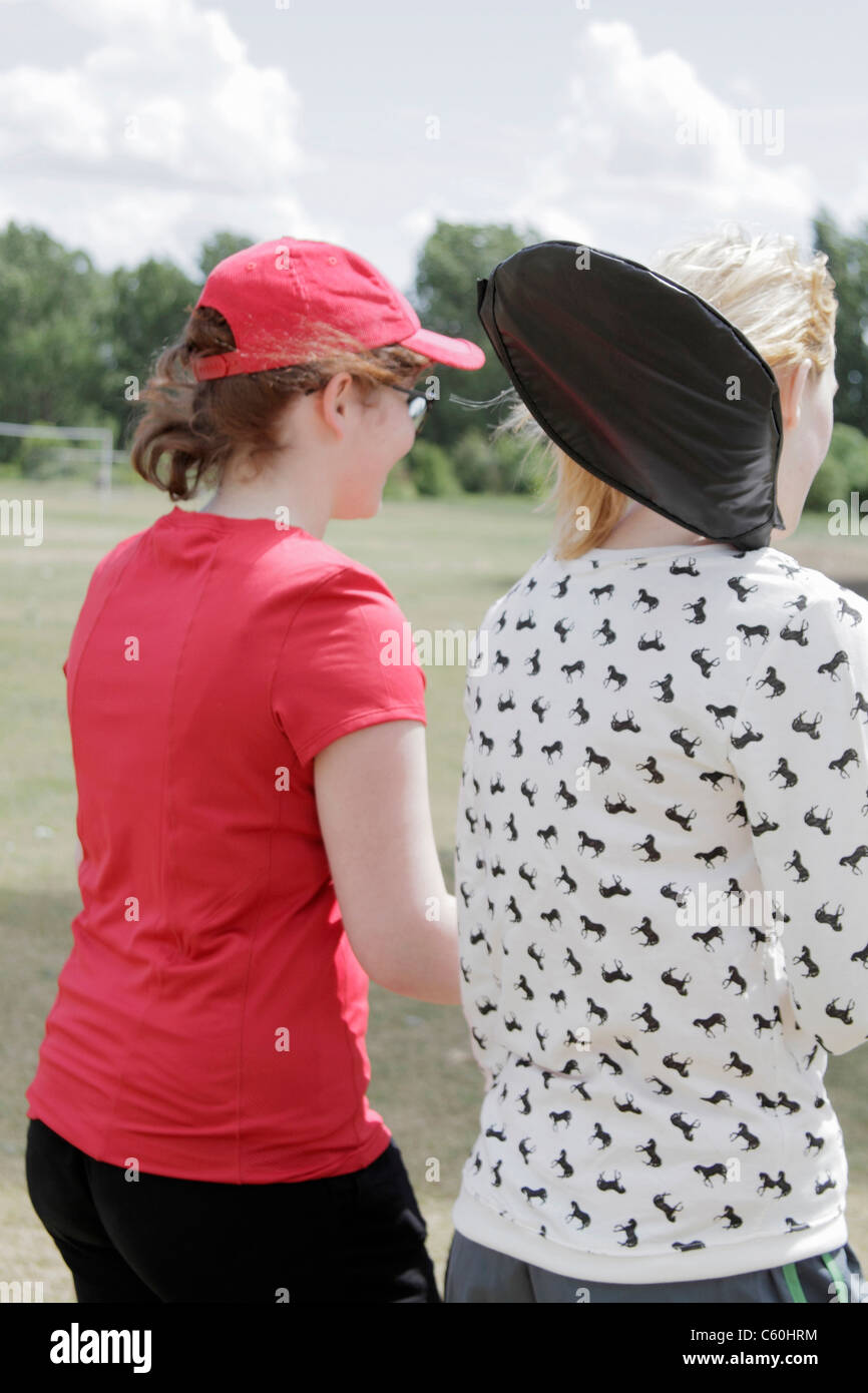 Girls walking in park together Stock Photo - Alamy
