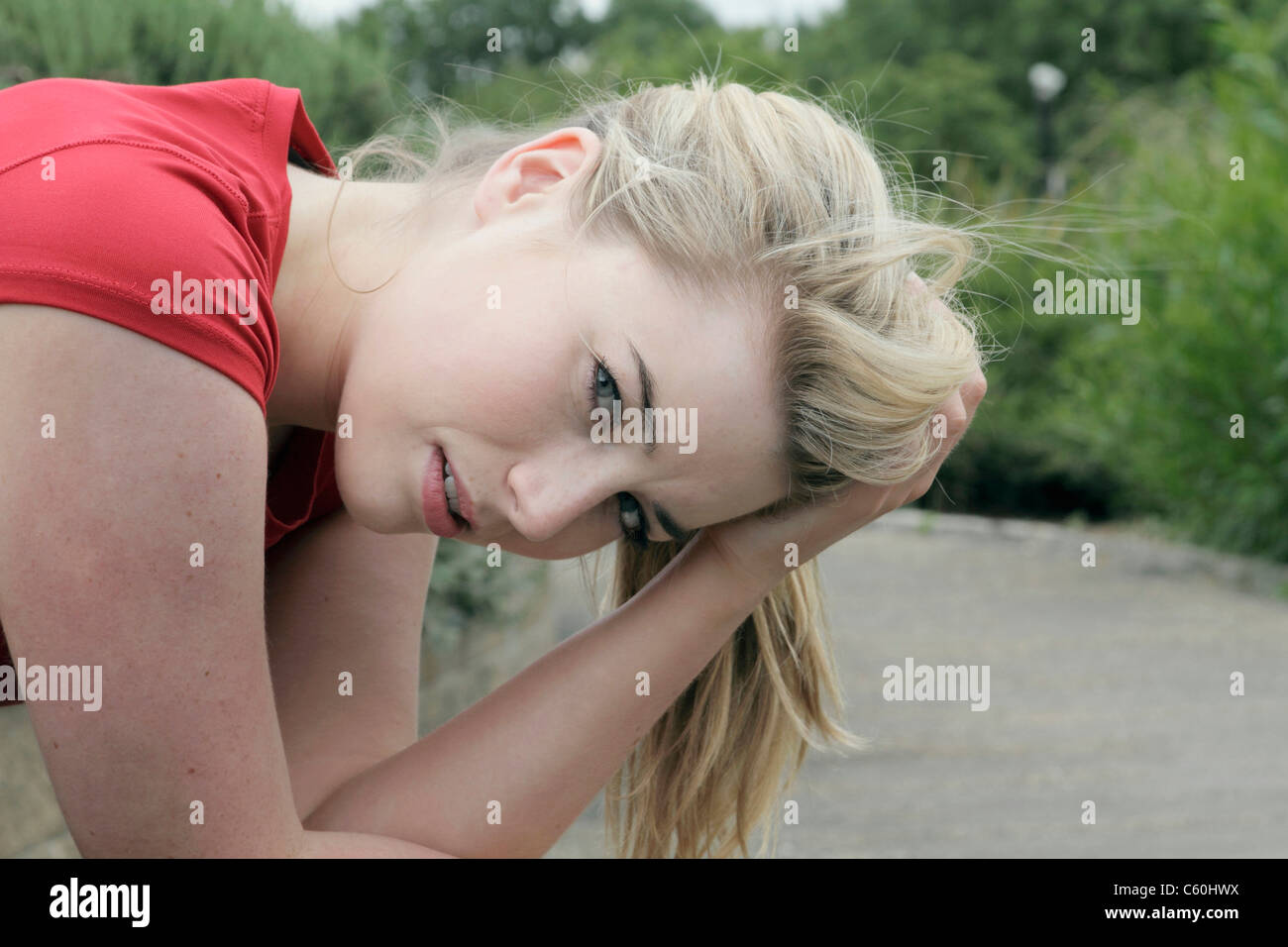 Serious woman resting in park Stock Photo - Alamy