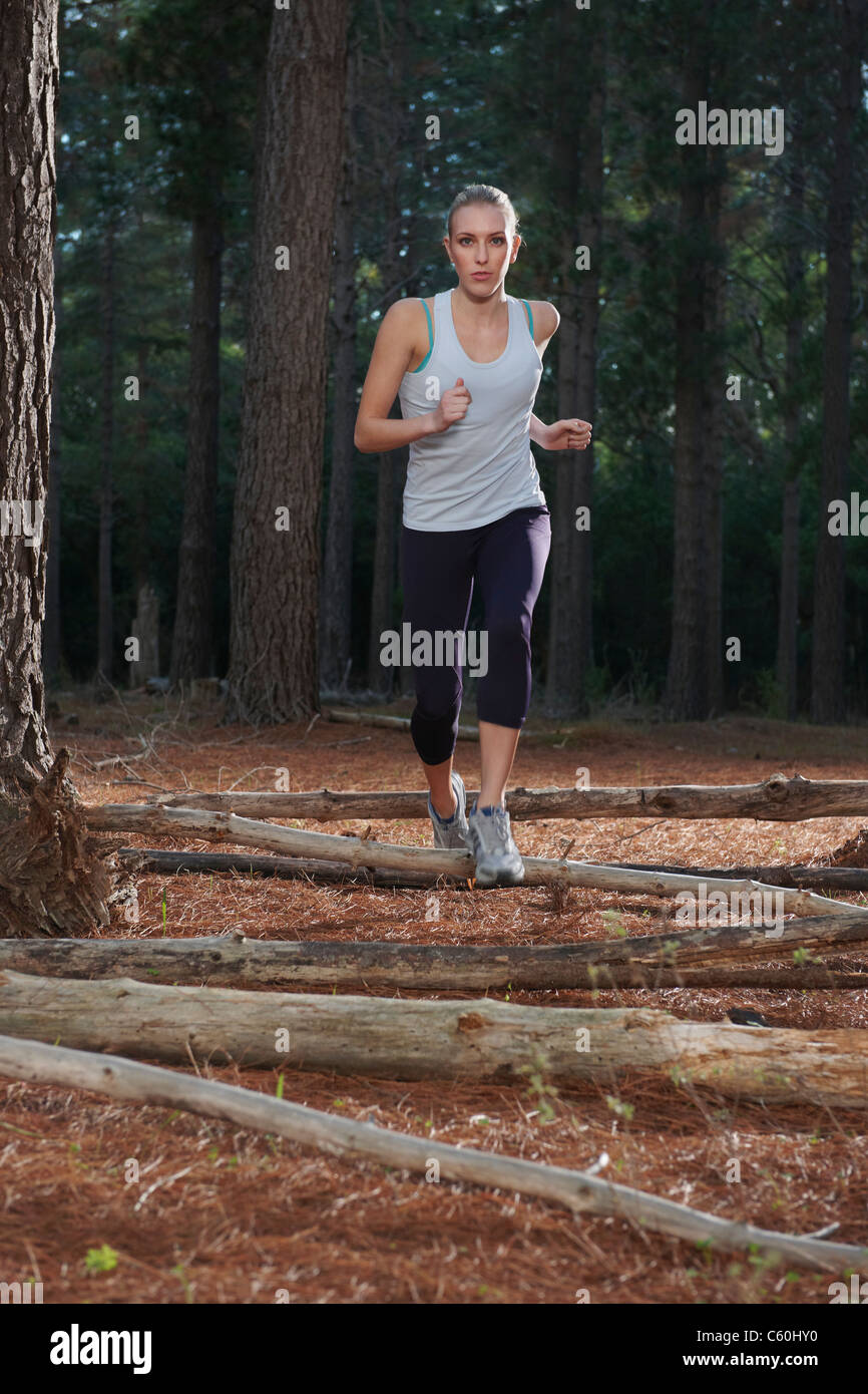 Woman running in forest Stock Photo - Alamy