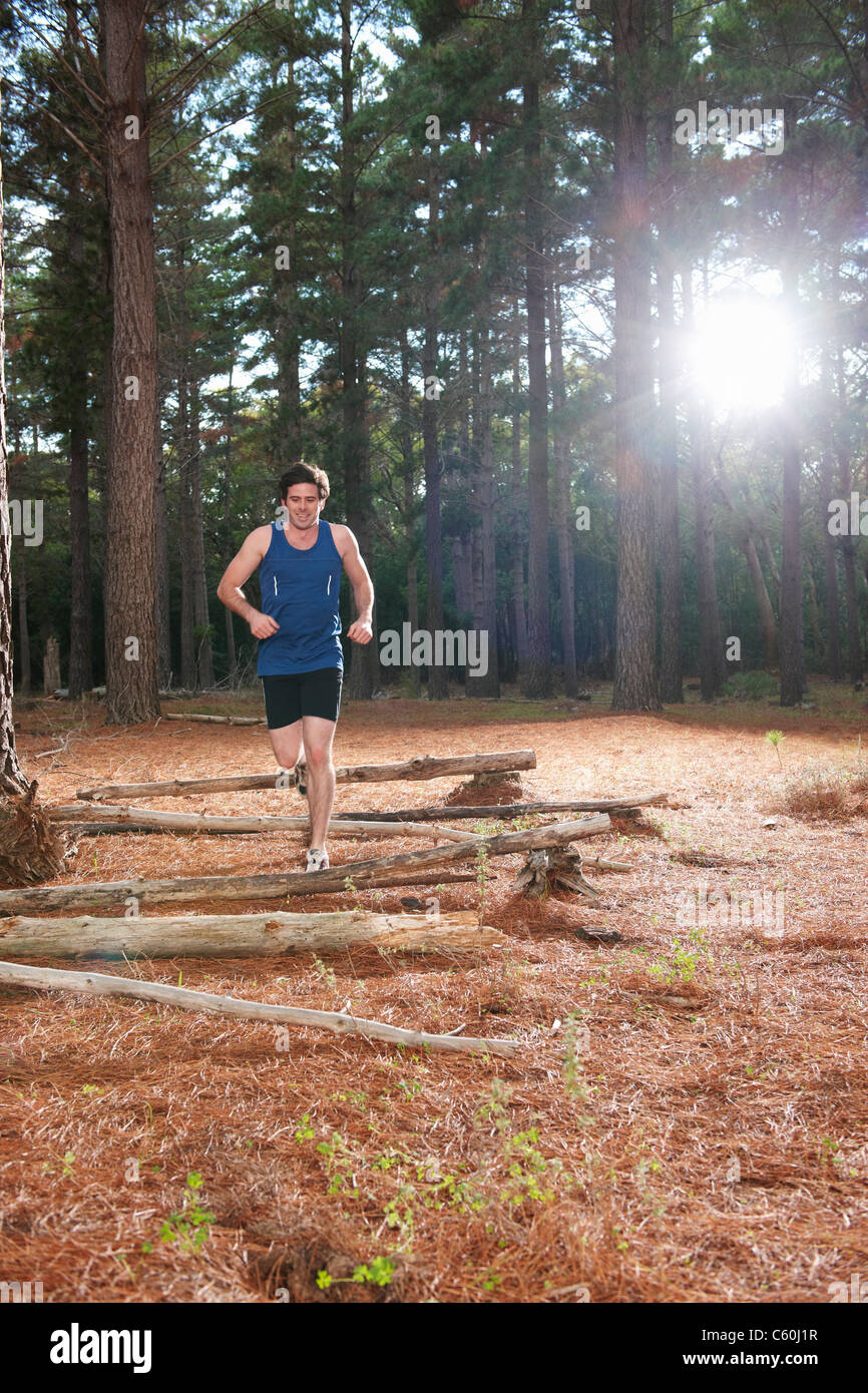 Man running in forest Stock Photo - Alamy