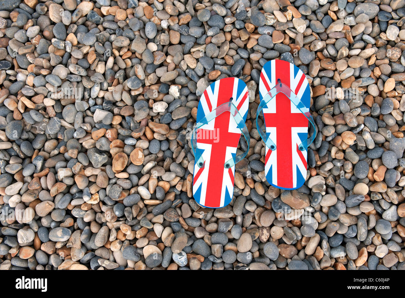 union jack flip flops on shingle beach Stock Photo - Alamy