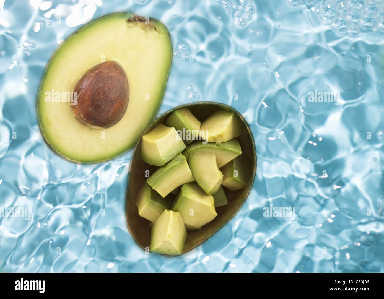 Avocado floating on water Stock Photo - Alamy