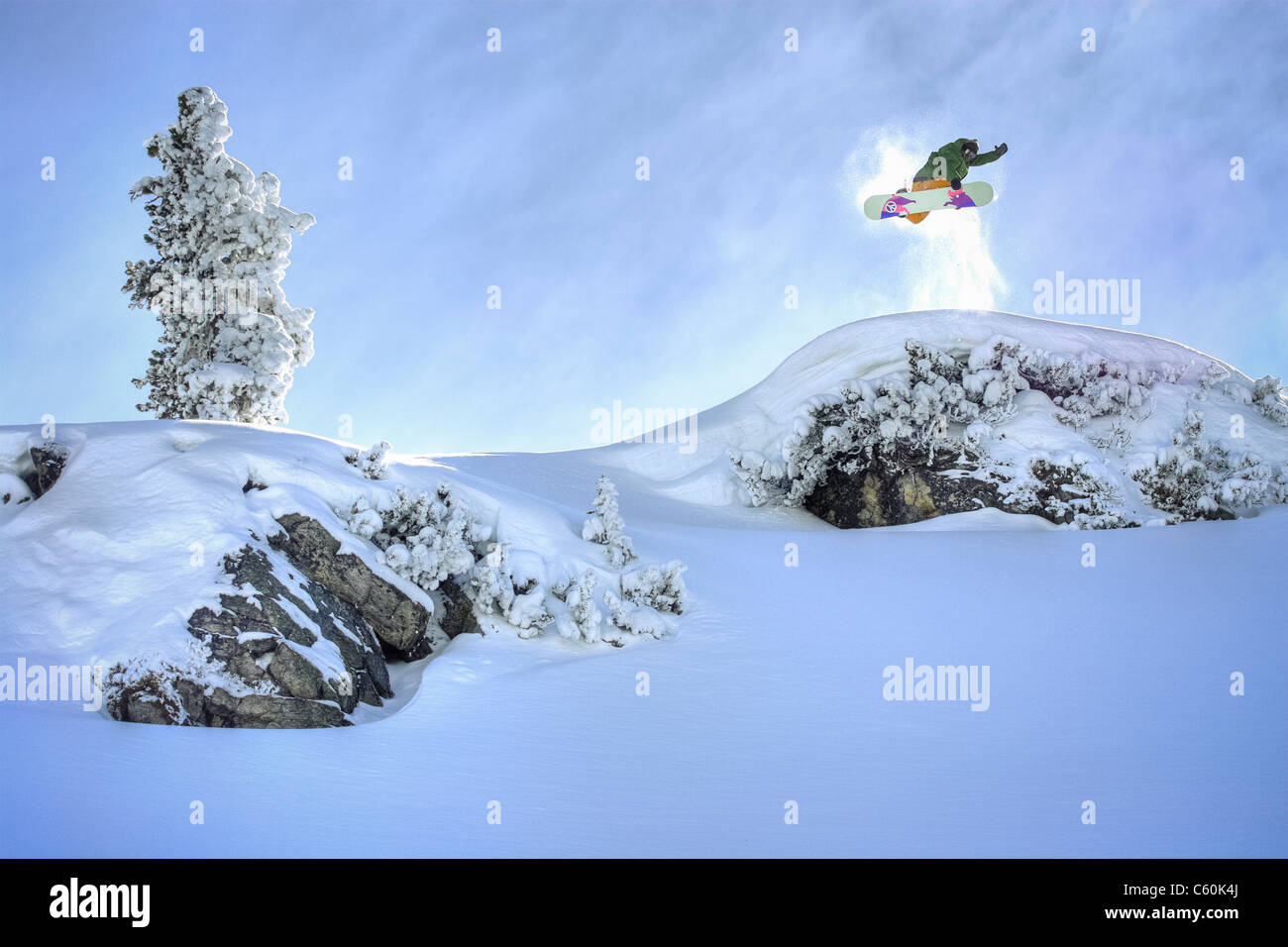 Snowboarder jumping from hillside Stock Photo - Alamy