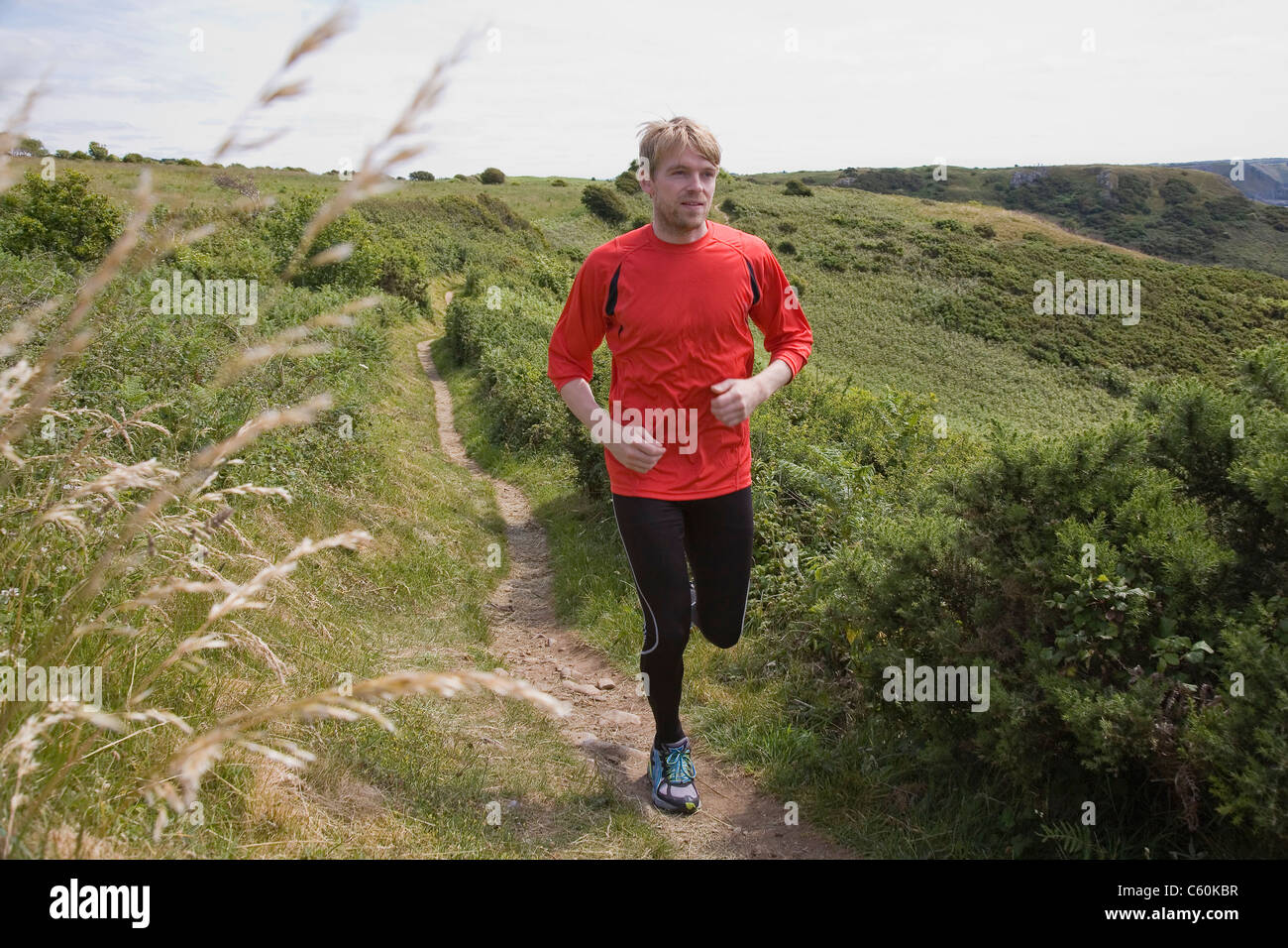 Man running on rural path Stock Photo - Alamy