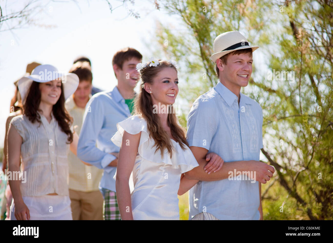 Bridal procession walking on rural path Stock Photo - Alamy