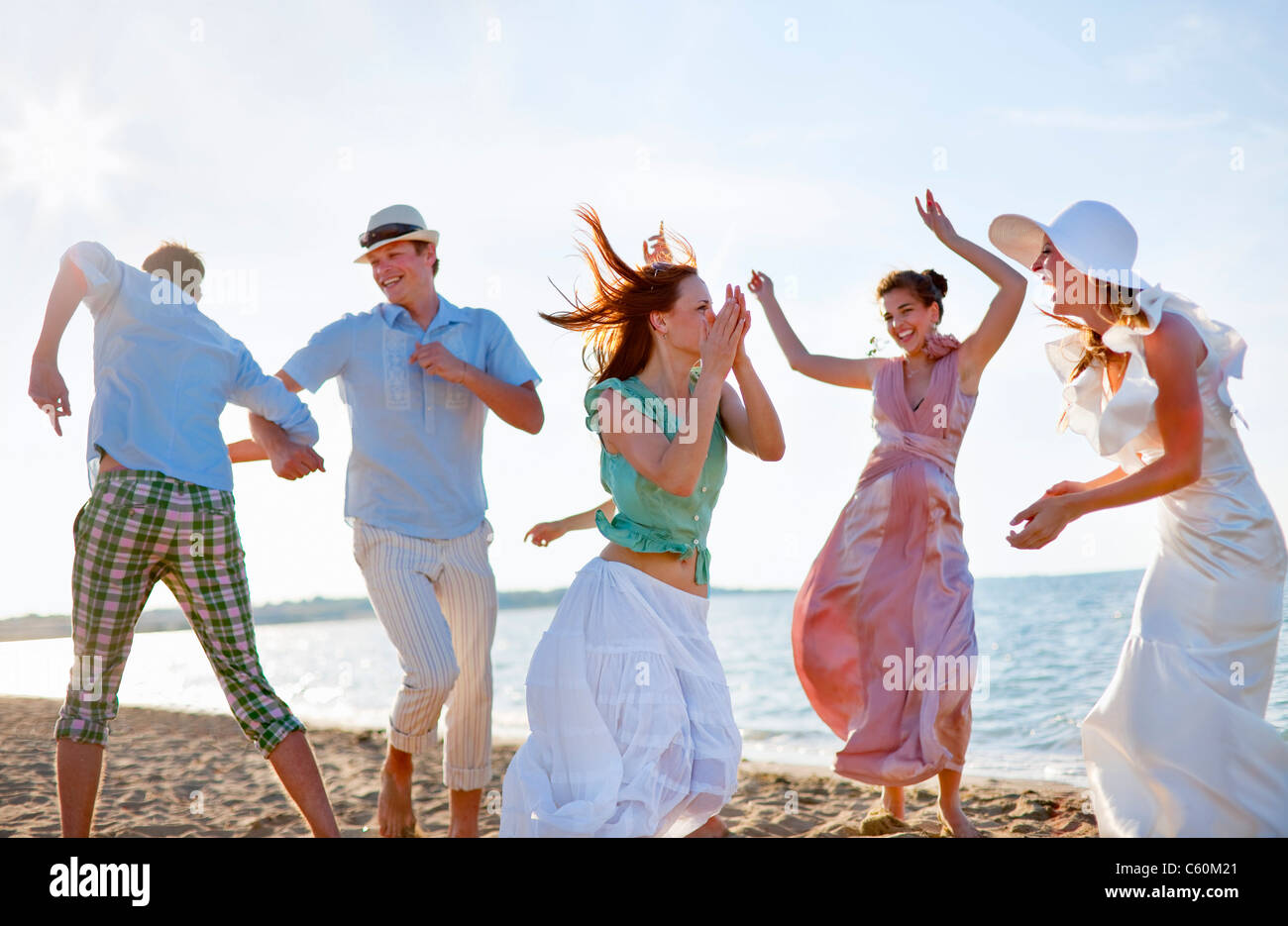 People dancing together on beach Stock Photo - Alamy
