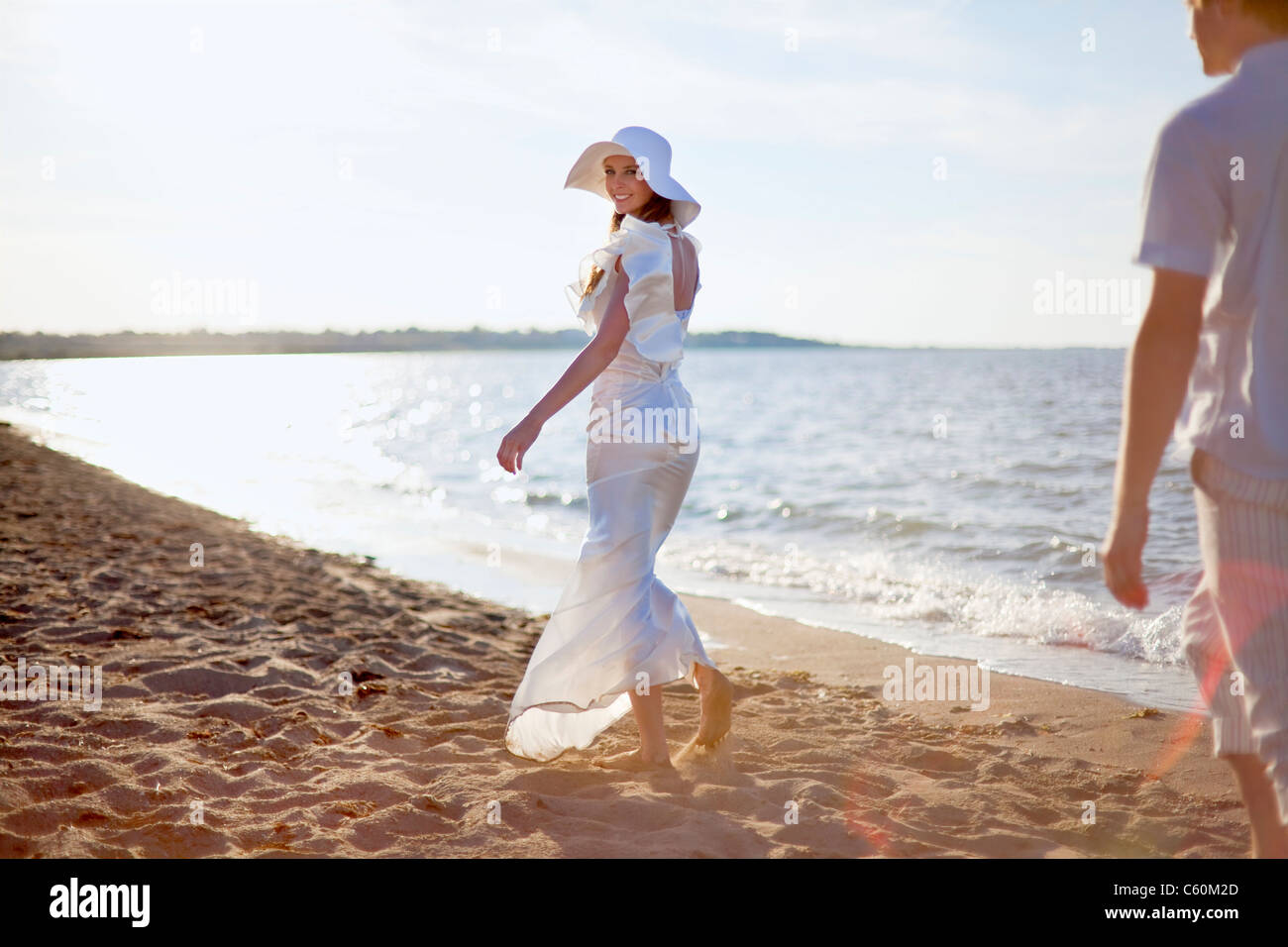 Bride walking on beach Stock Photo - Alamy