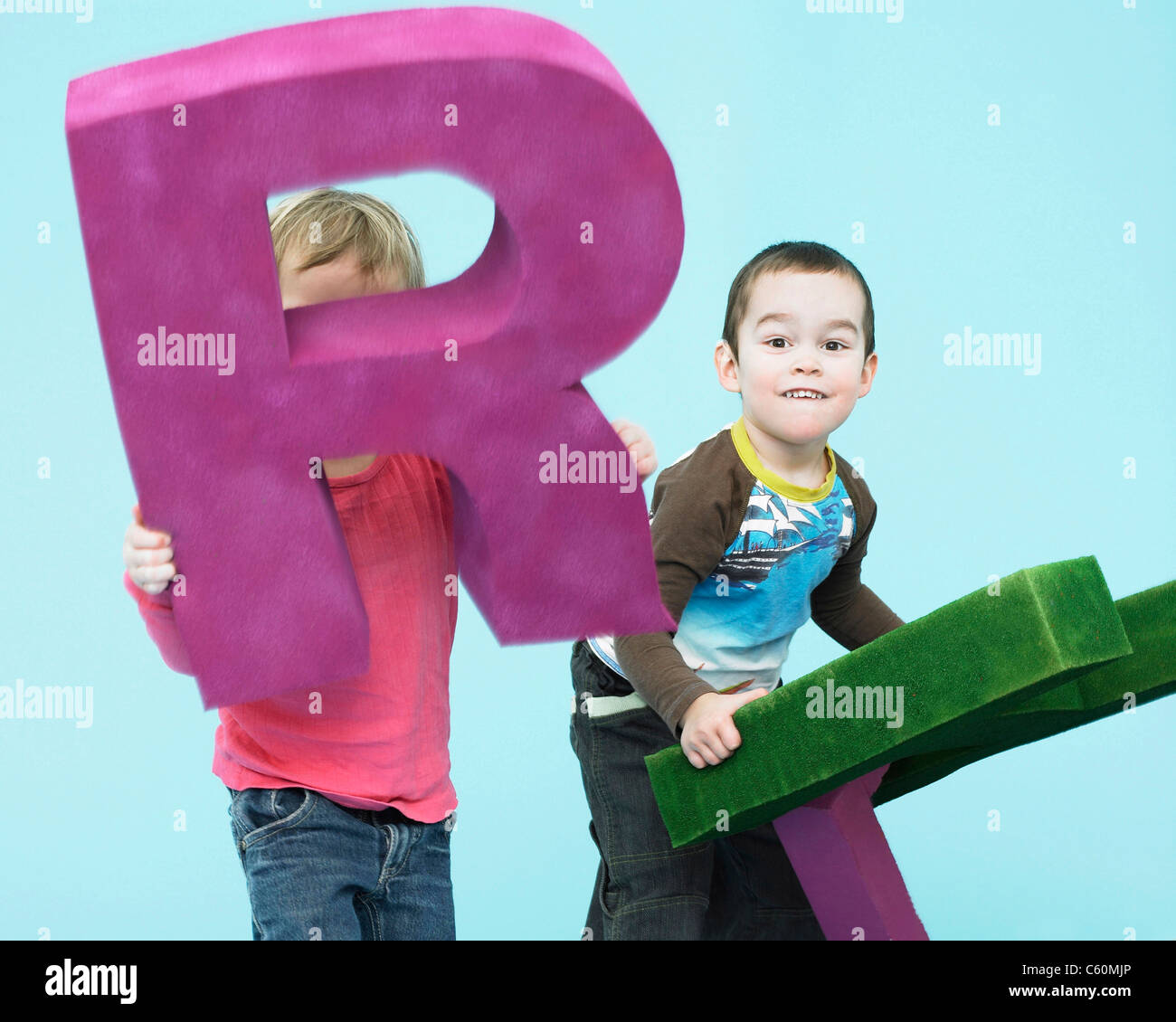 Toddlers playing with oversize letters Stock Photo - Alamy Toddlers playing with oversize letters Stock Photo - Alamy