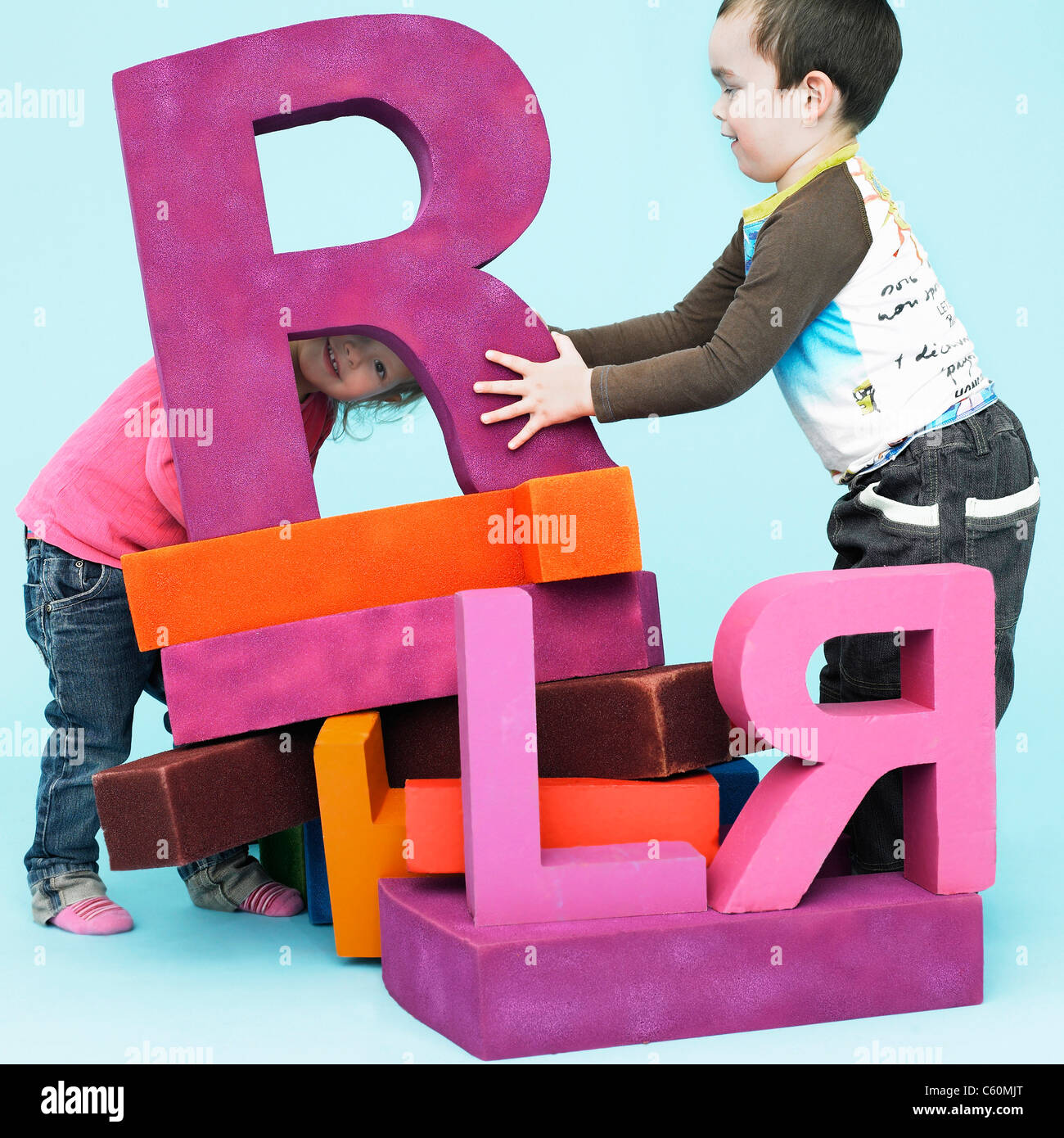 Toddlers playing with oversize letters Stock Photo - Alamy Toddlers playing with oversize letters Stock Photo - Alamy