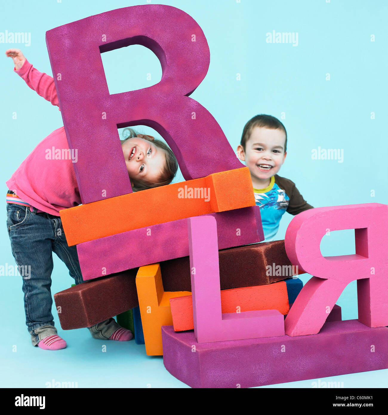 Toddlers playing with oversize letters Stock Photo - Alamy Toddlers playing with oversize letters Stock Photo - Alamy