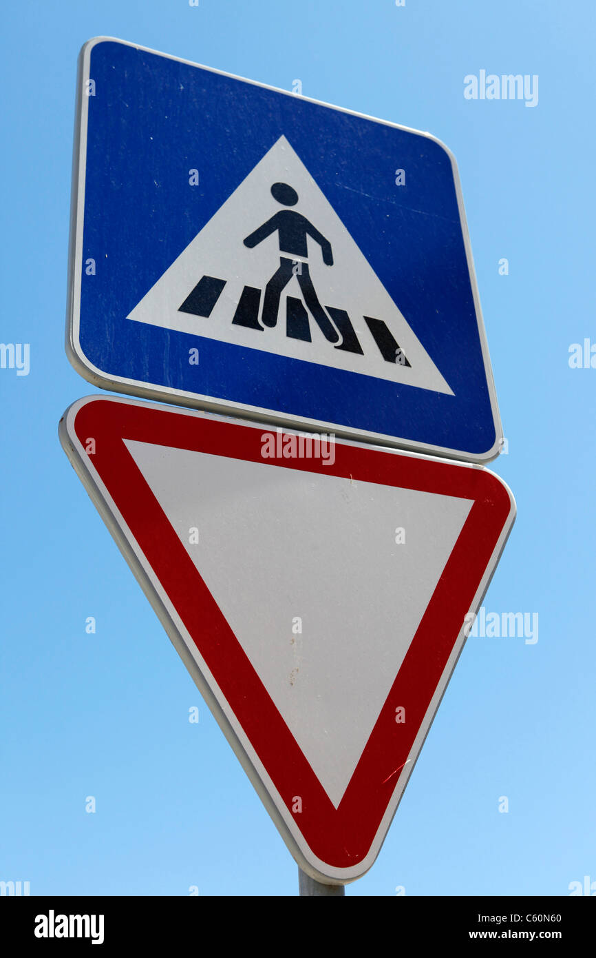 A traffic sign warns drivers to give priority to pedestrians on a ...