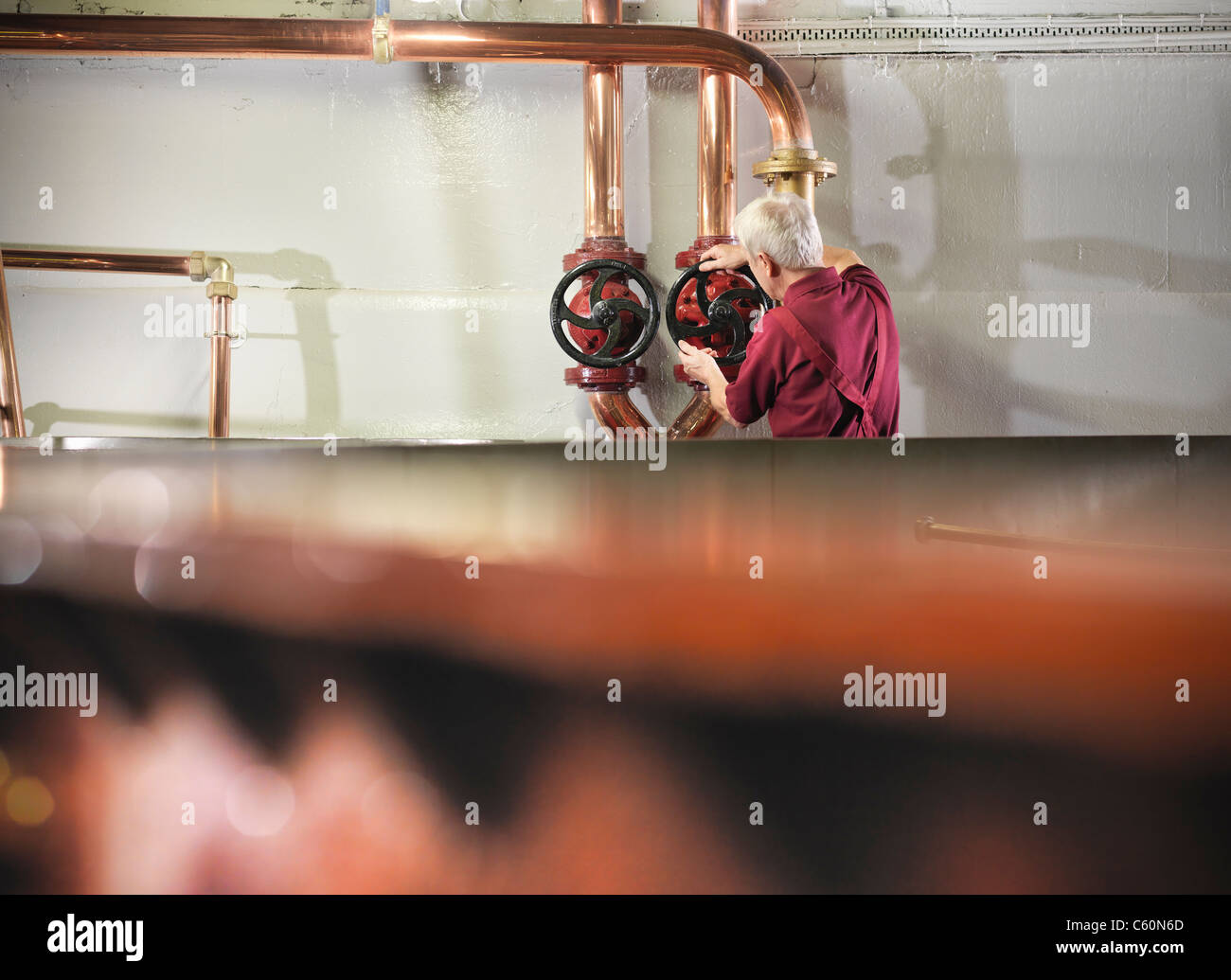 Two men turning valve hi-res stock photography and images - Alamy