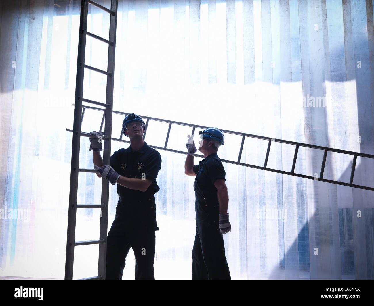 Carrying ladders hi-res stock photography and images - Alamy