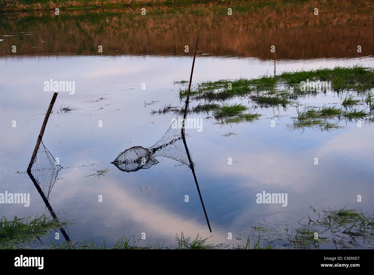 The sweep-net placed in a pond. Sky mirror in water Stock Photo - Alamy