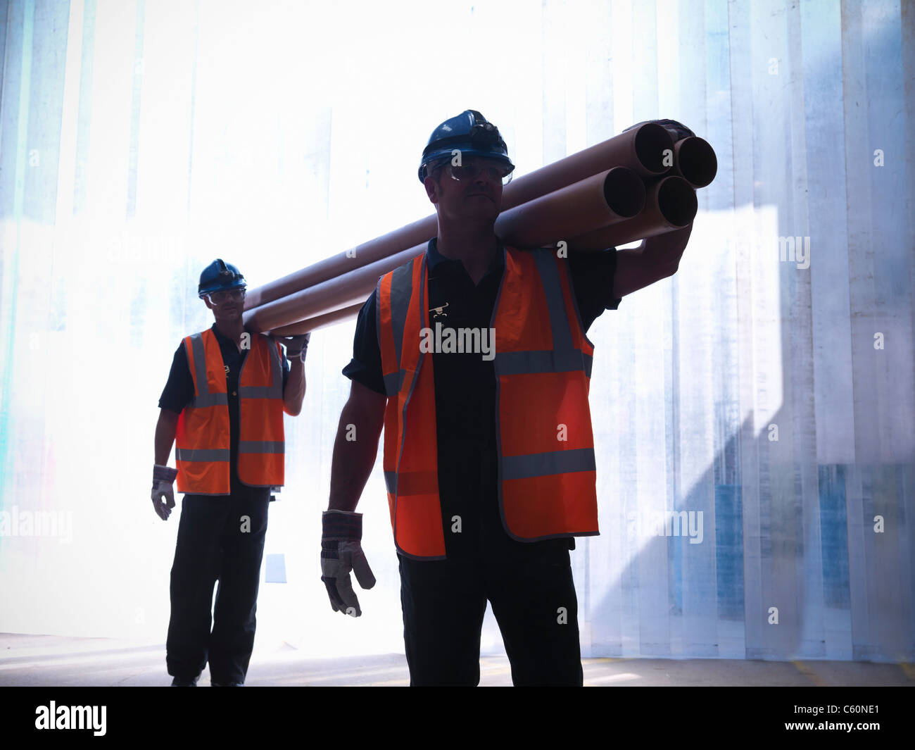 Construction worker carrying pipes hi-res stock photography and images ...
