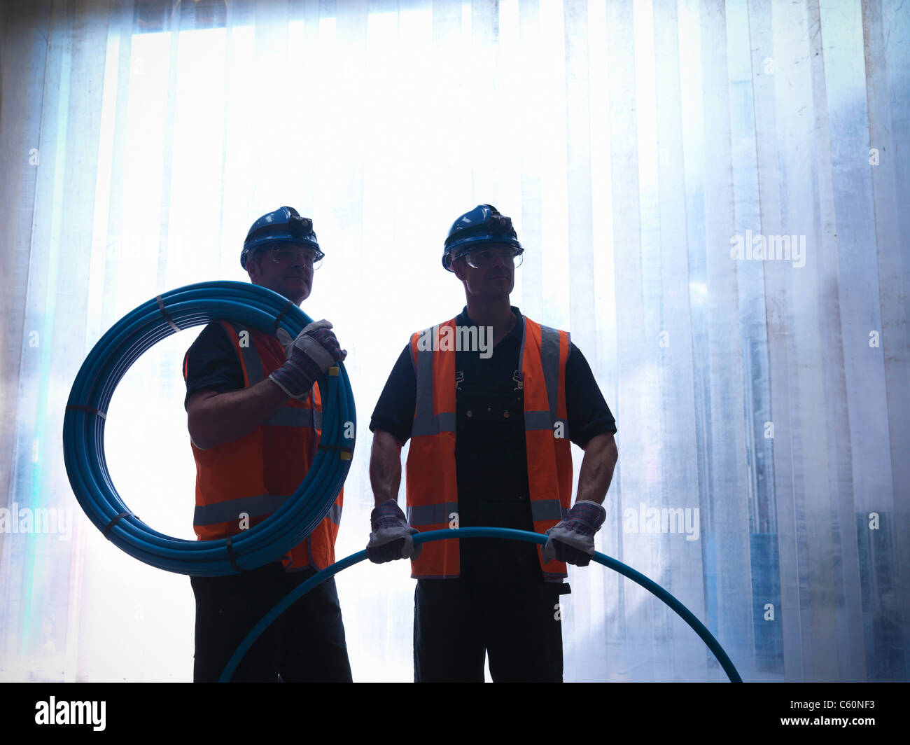 Construction worker carrying pipes hi-res stock photography and images ...