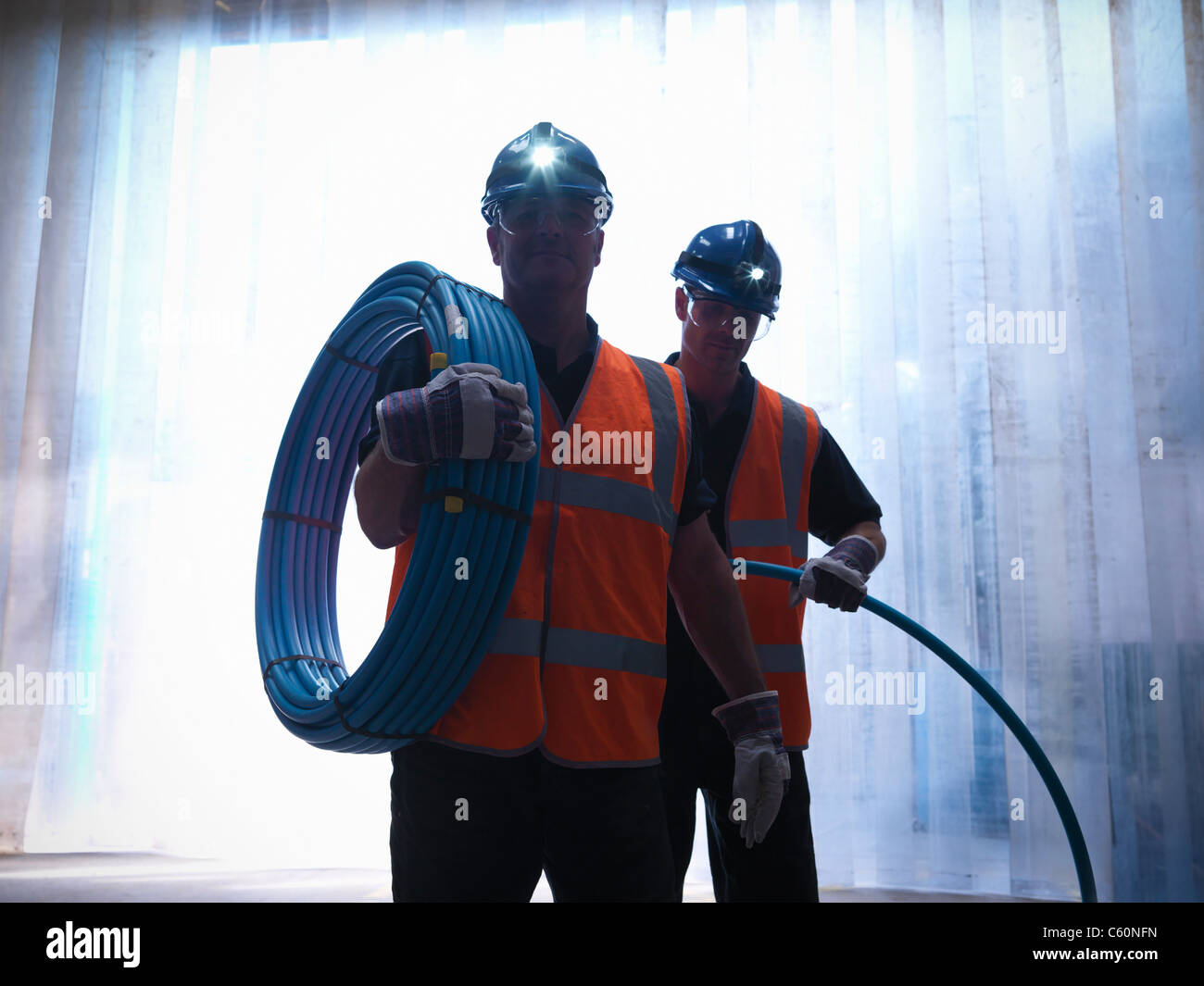 Construction worker carrying pipes hi-res stock photography and images ...