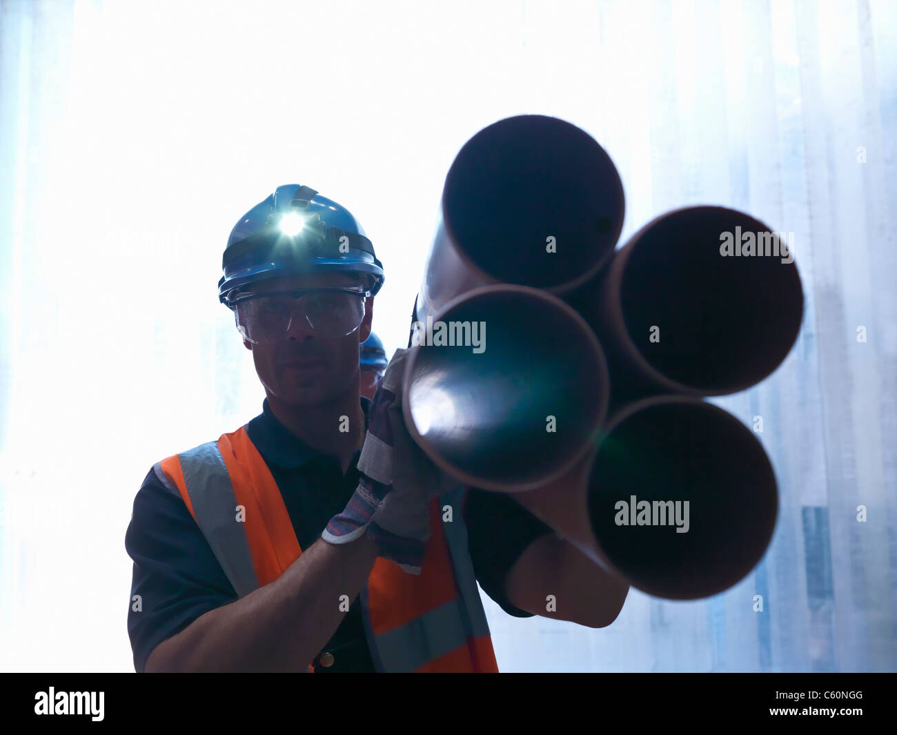 Construction worker carrying pipes hi-res stock photography and images ...