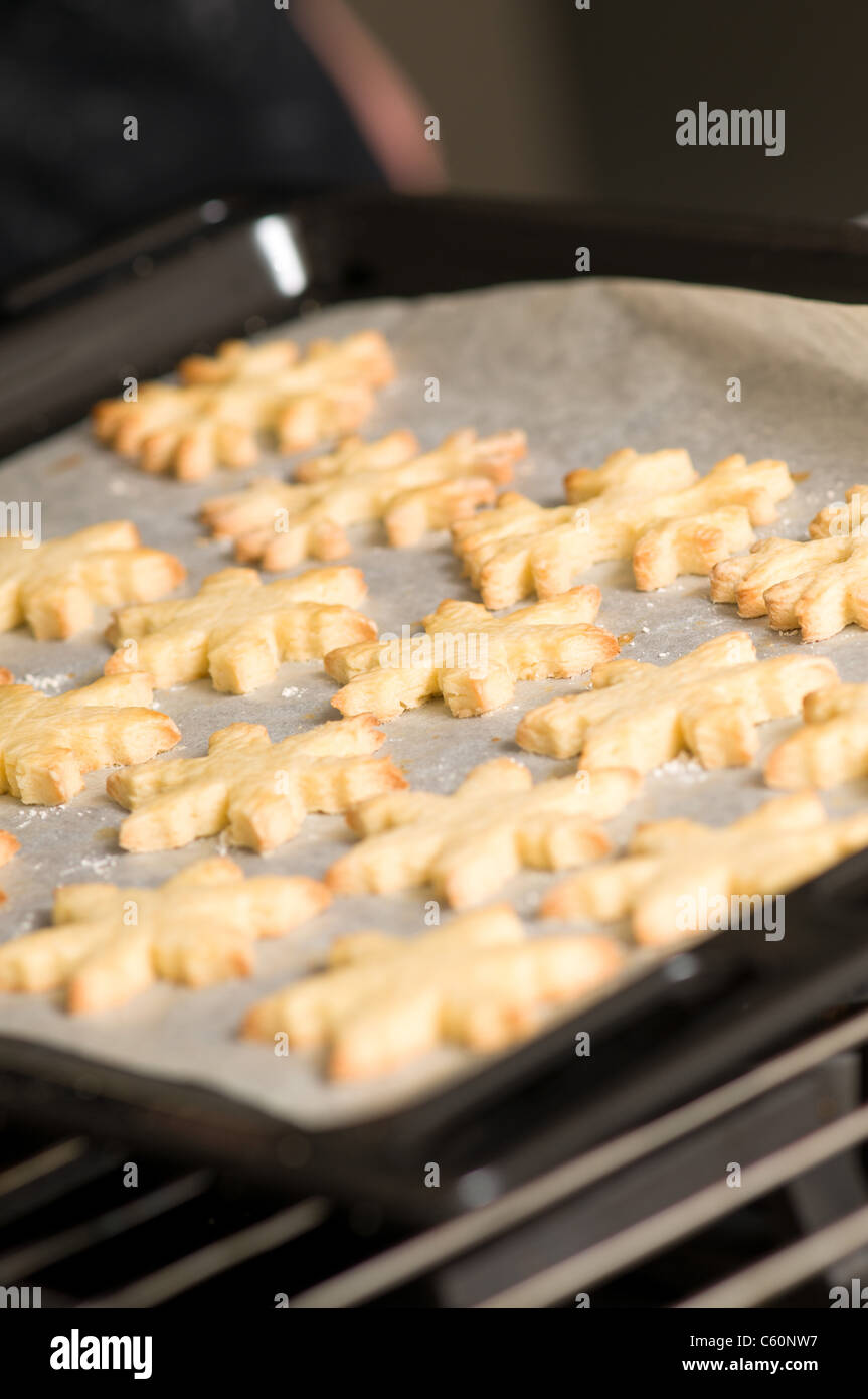 Ready backed star shape cookies on backing paper in a tray Stock Photo ...