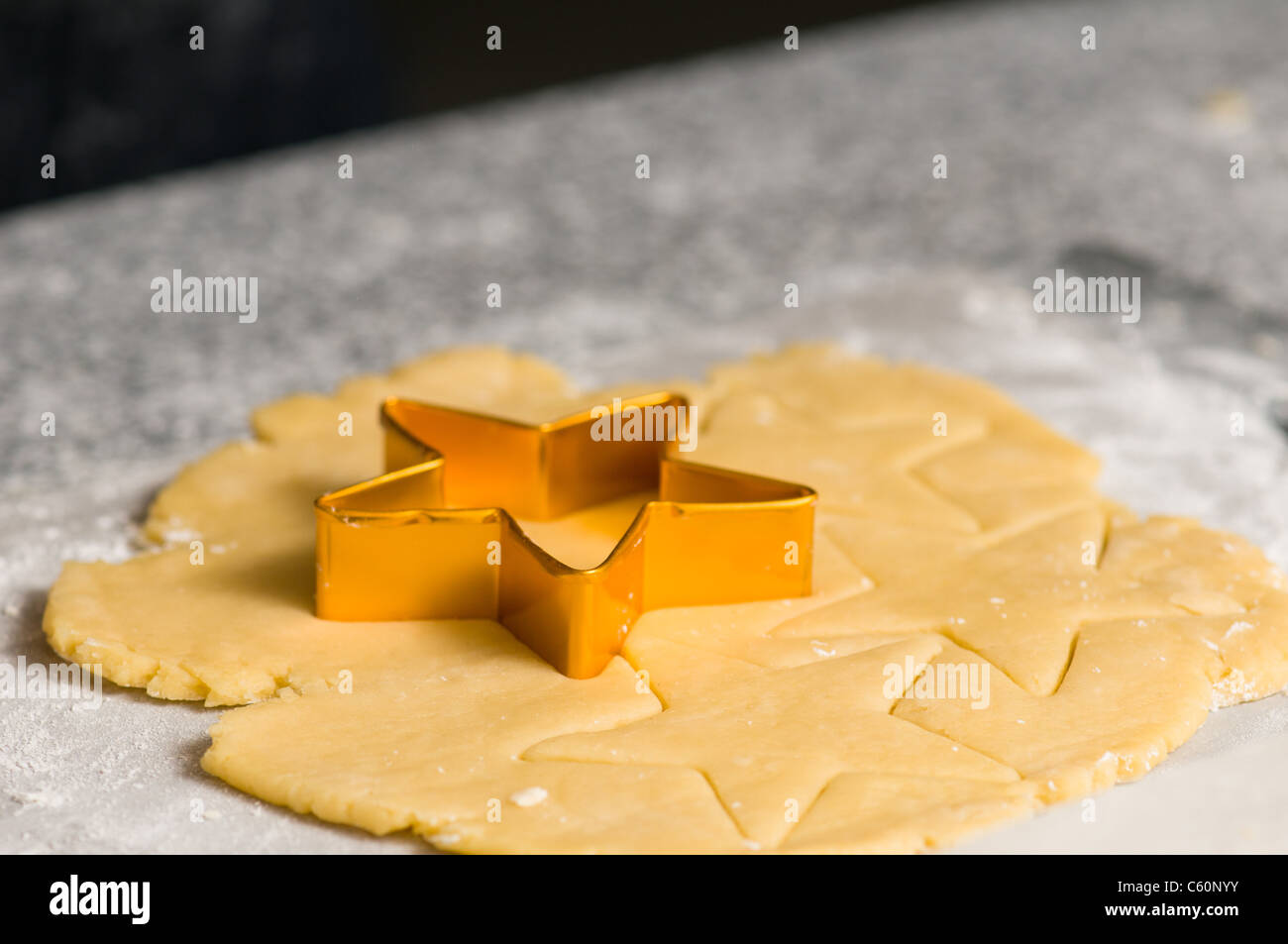 Star shape cookie cutter on dough pre cutted dough Stock Photo - Alamy