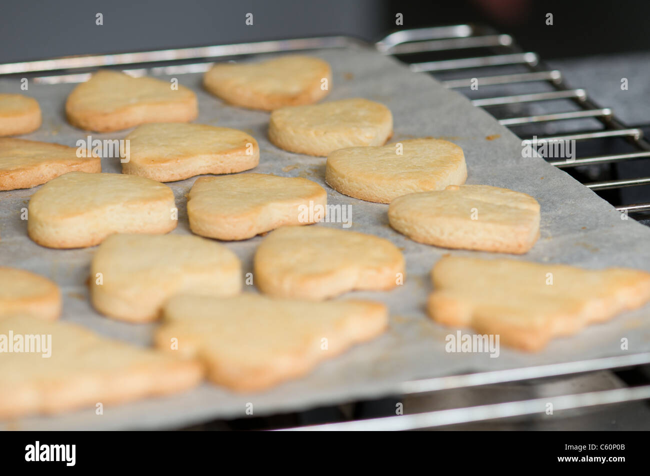 Ready backed heart shape cookies on backing paper in a tray Stock Photo ...