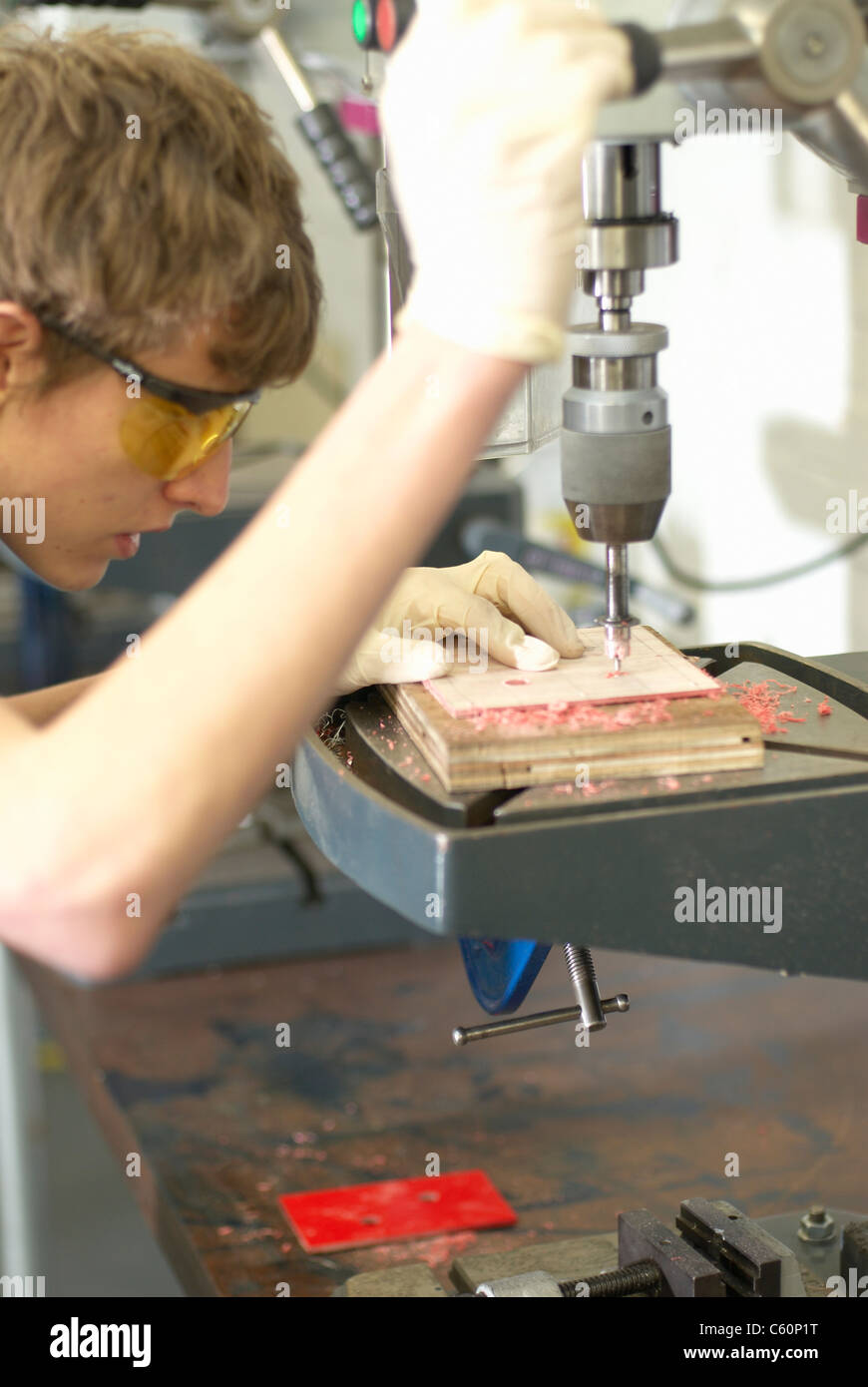 Worker using drill in factory Stock Photo - Alamy