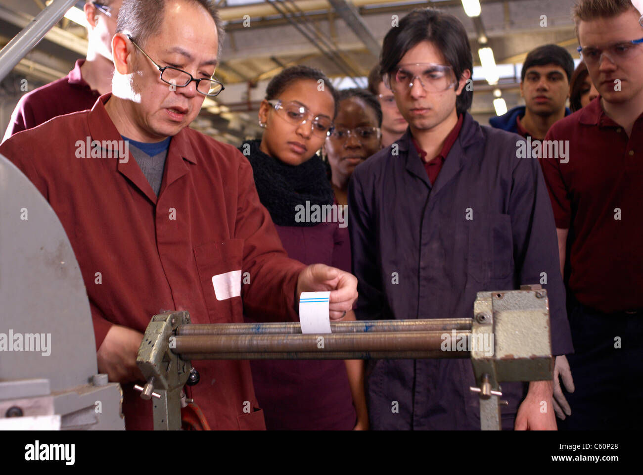 Worker using rollers in factory Stock Photo - Alamy