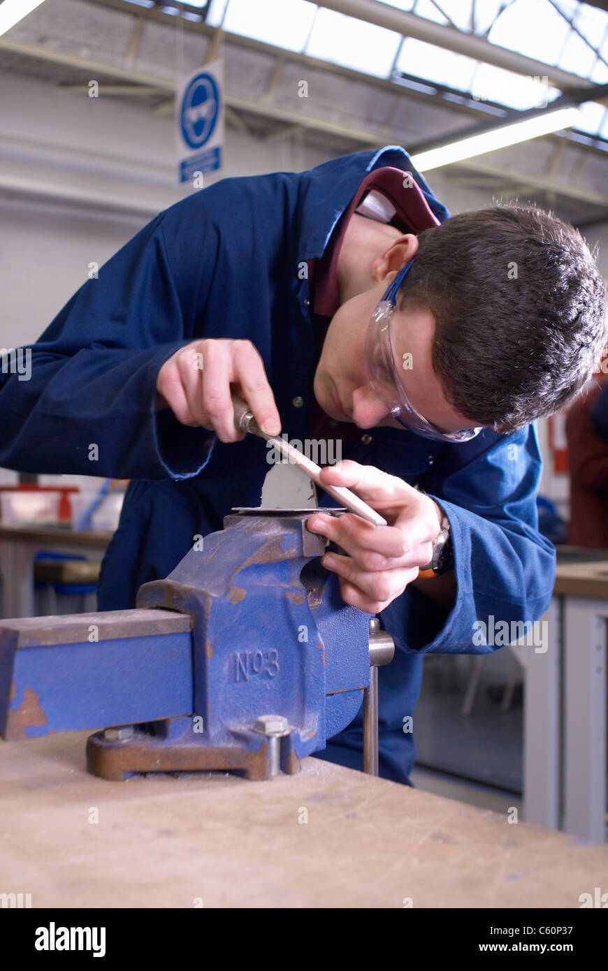 Worker using saw in factory Stock Photo - Alamy