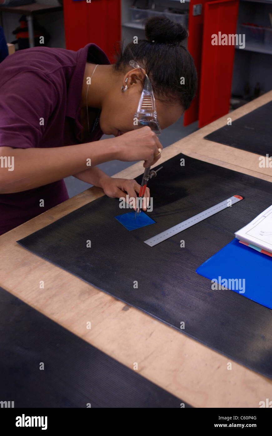 Worker tracing with compass in factory Stock Photo - Alamy