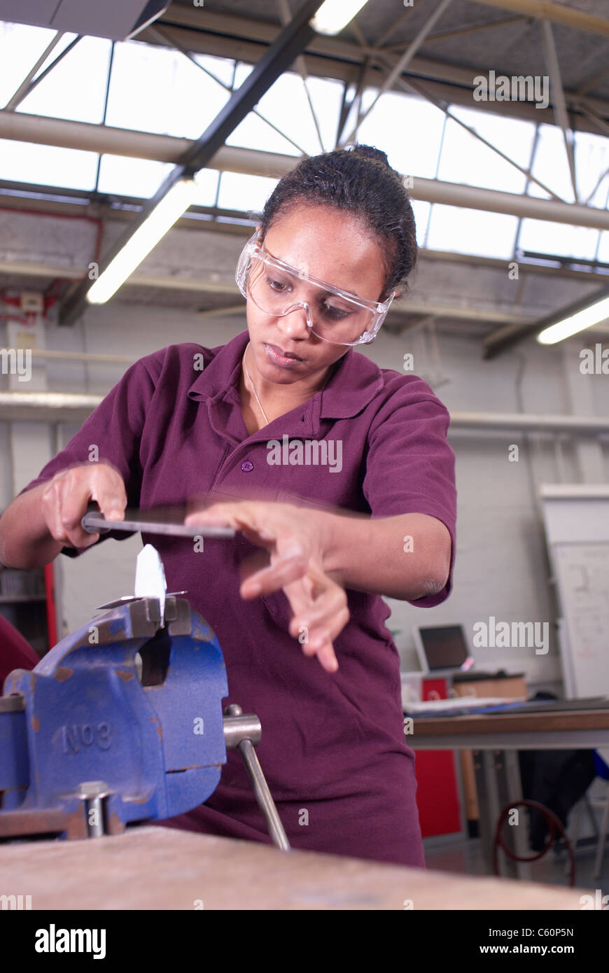 Worker using saw in factory Stock Photo - Alamy